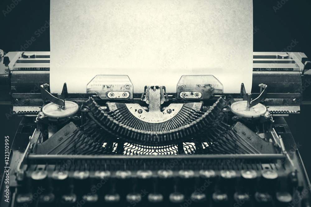 Typewriter with paper sheet with black background and retro tone. Space ...