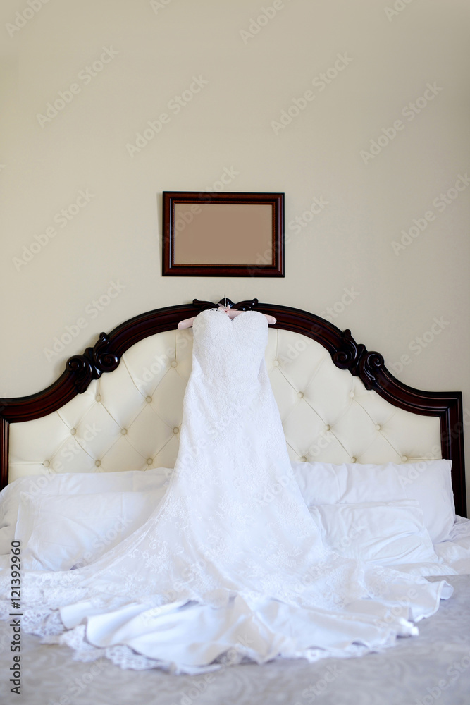 Beautiful white wedding dress for bride indoors on the bed. Beauty of ...