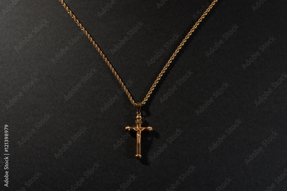 gold cross on a chain on a black background Stock Photo | Adobe Stock