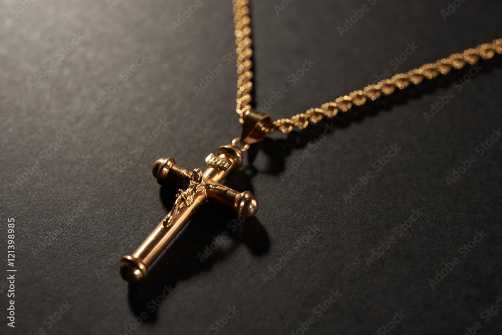 gold cross on a chain on a black background Stock Photo | Adobe Stock