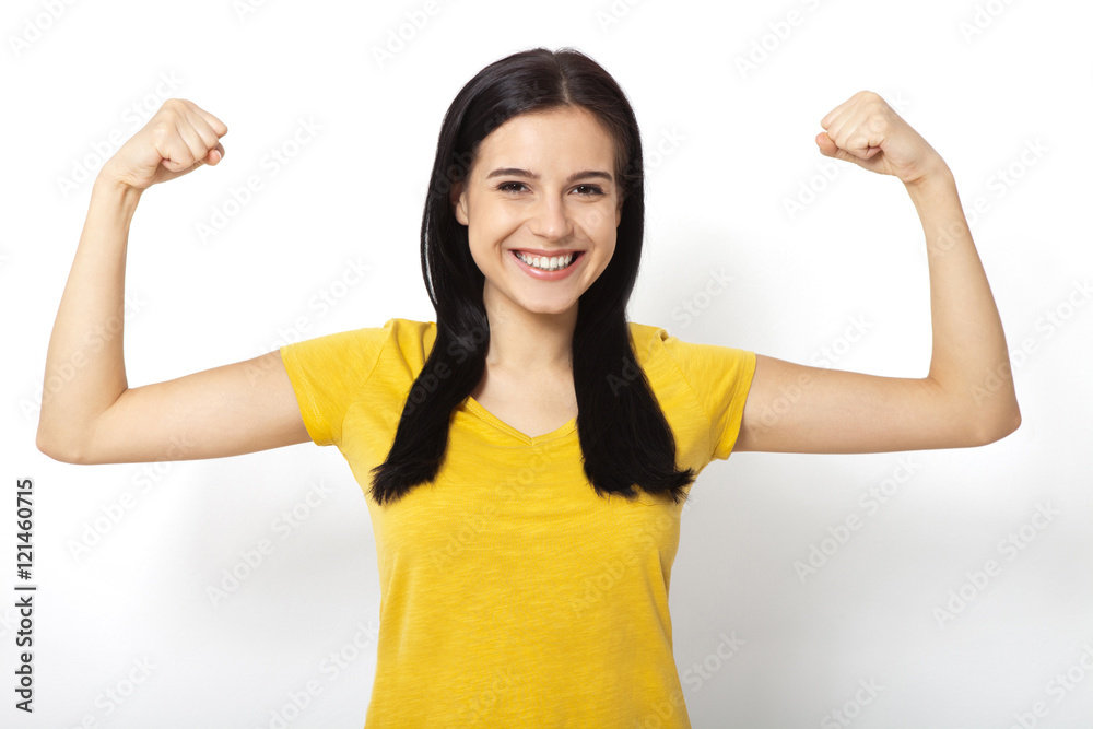 Strong woman. Beautiful girl showing her muscularity, looking at camera ...