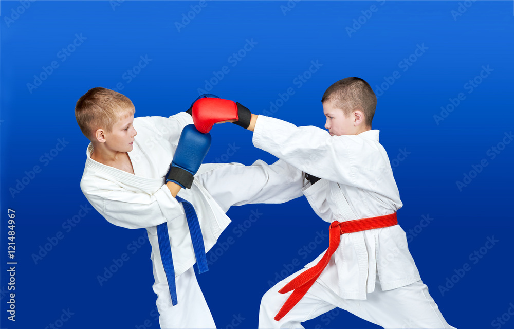 Roundhouse kick leg and a straight punch arm athletes are beating the ...