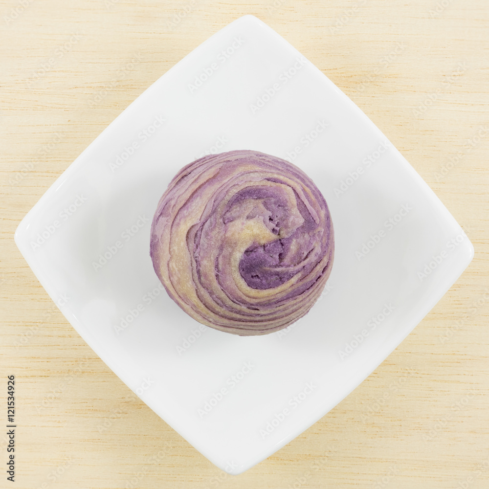 The Taiwanese violet crystal taro cake on the small white square dish ...