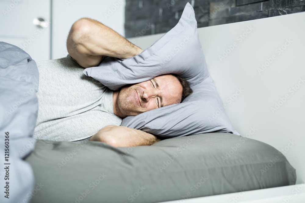 Tired man in the bed Foto Stok | Adobe Stock
