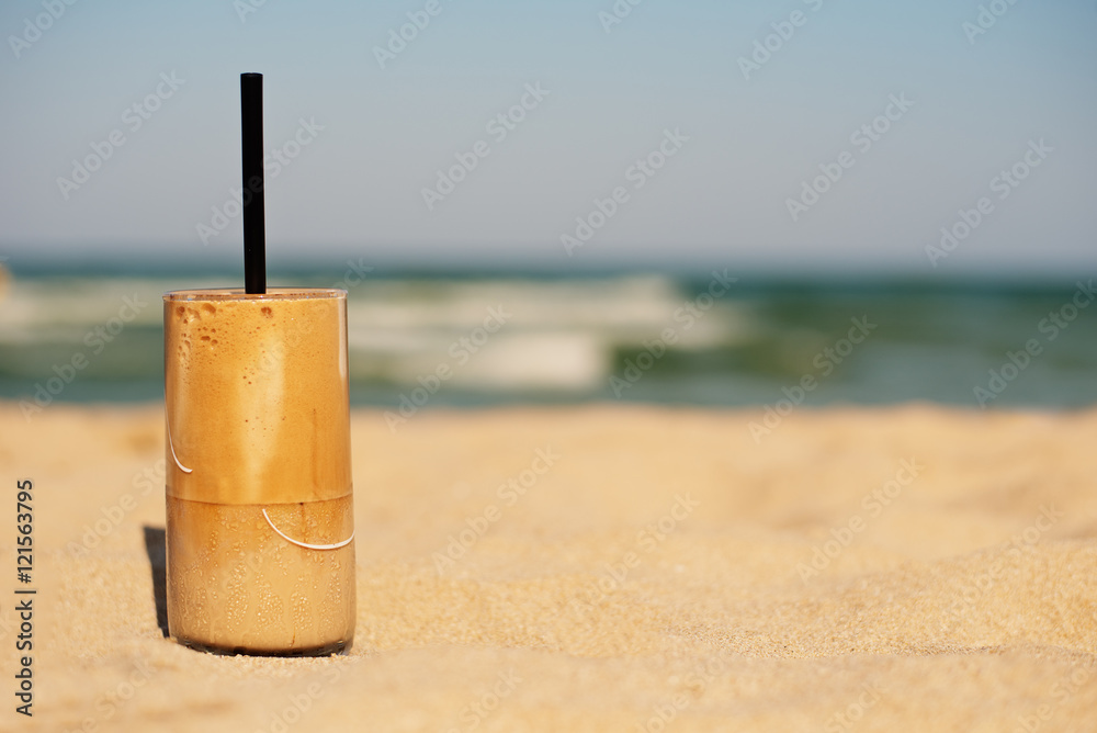 Frappe, ice coffee on the beach. Summer iced coffee (frappuccino ...