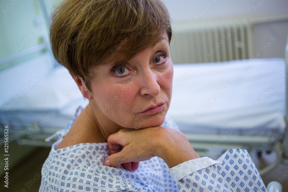 Portrait of sad senior patient sitting on a bed Stock Photo | Adobe Stock