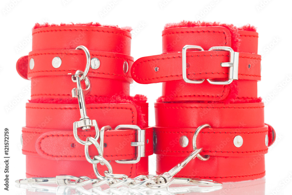Pair of a red color leather handcuffs isolate on white background with ...