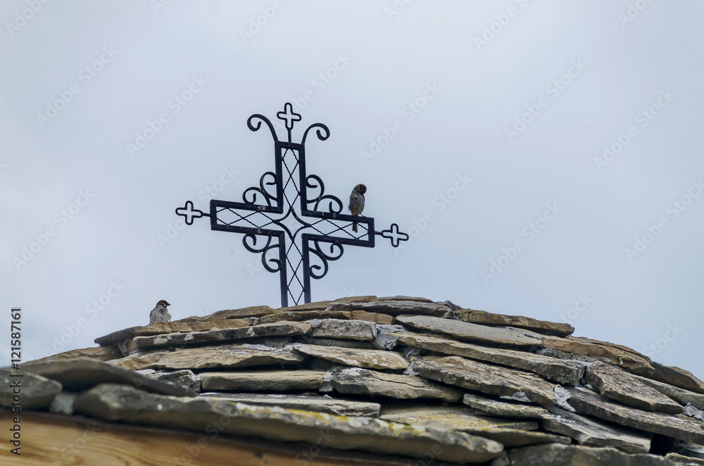 Stone slate-roof of old medieval church with cross in restored ...
