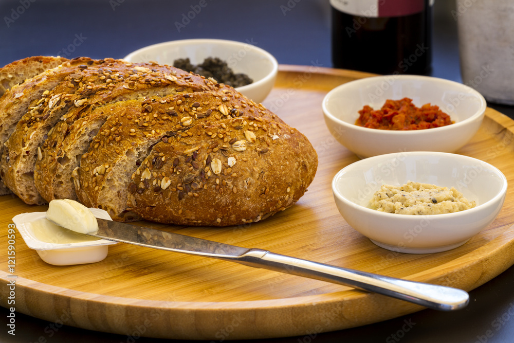 Fresh sliced country style whole grain bread with a mix of spreads and ...