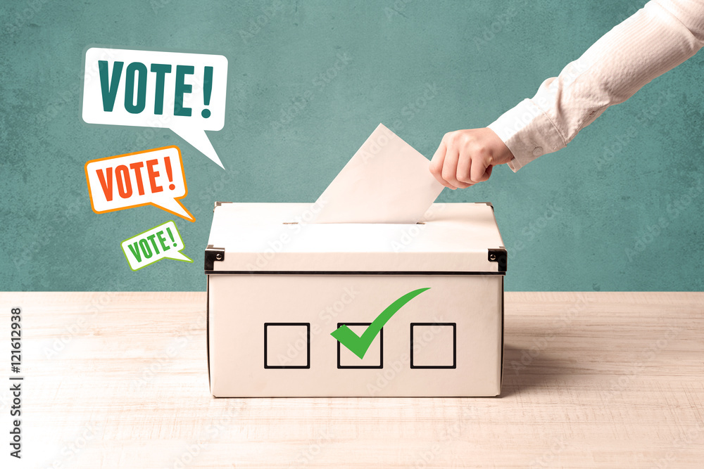 placing a voting slip into a ballot box Stock Photo | Adobe Stock