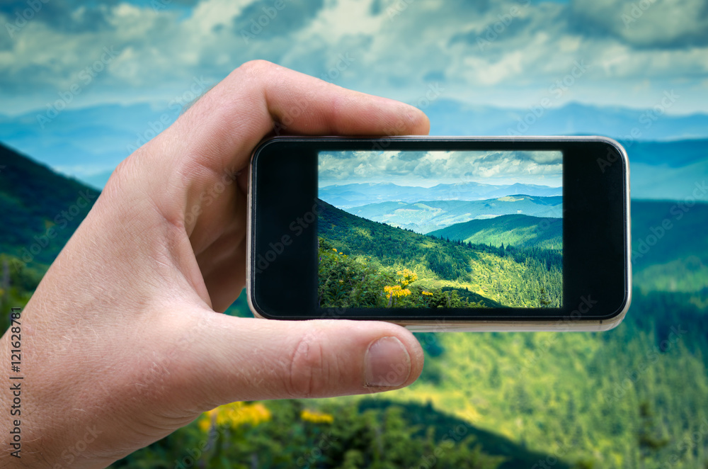 phone in a man's hand, mountain landscape photographs on your ...