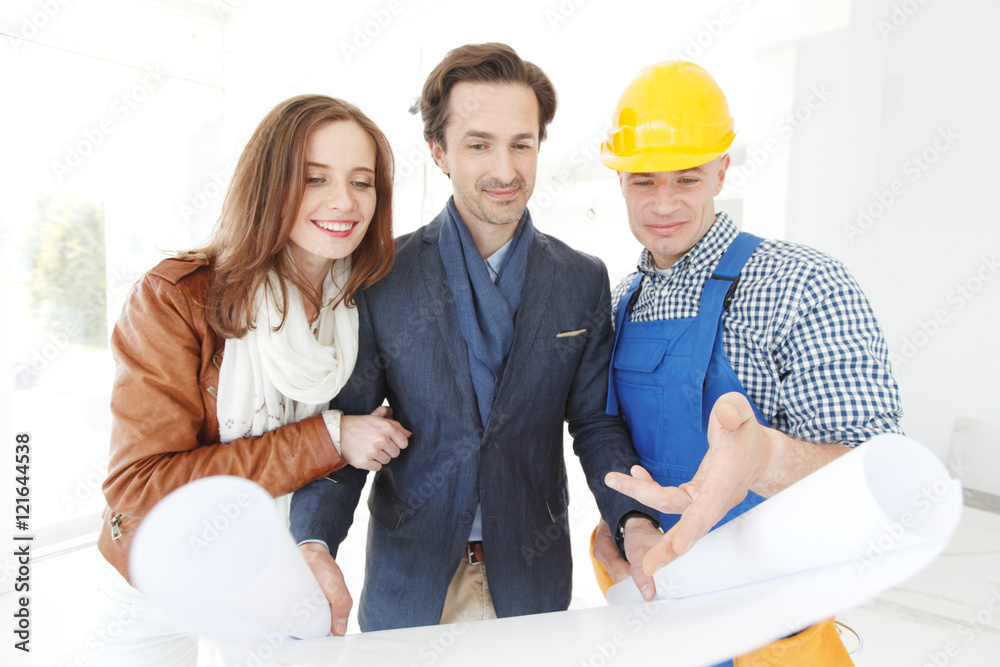 Worker shows house design plans Stock Photo | Adobe Stock