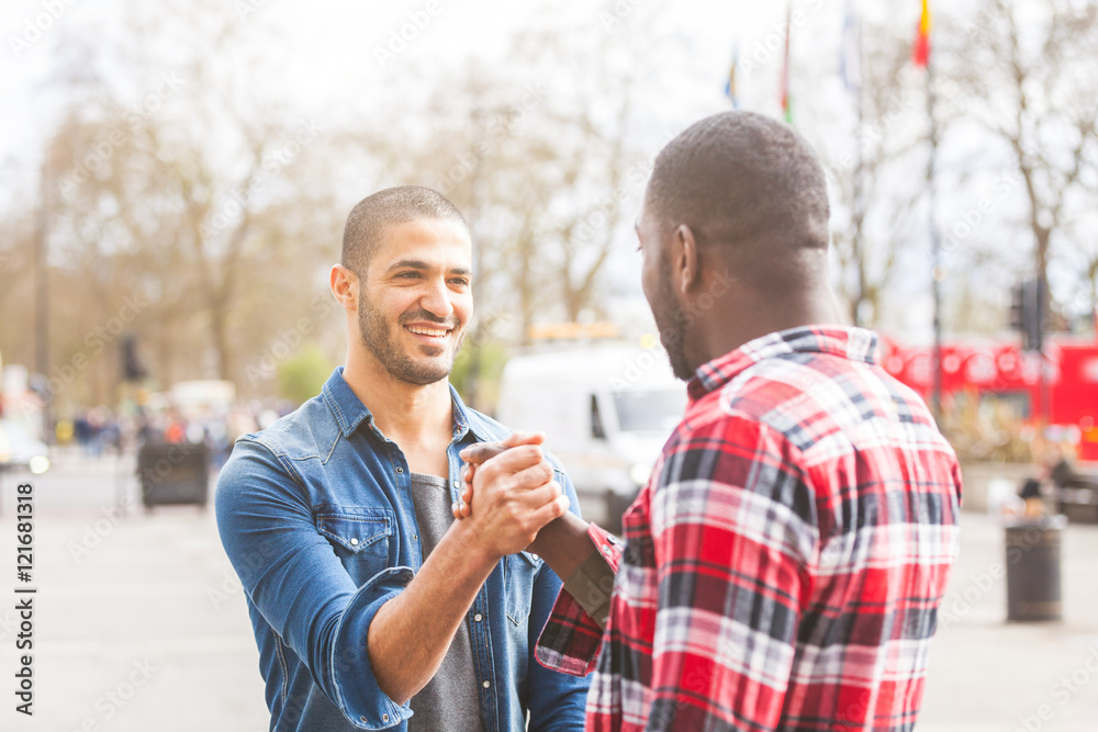 Two men giving a friendly handshake. A black man meeting his middle ...