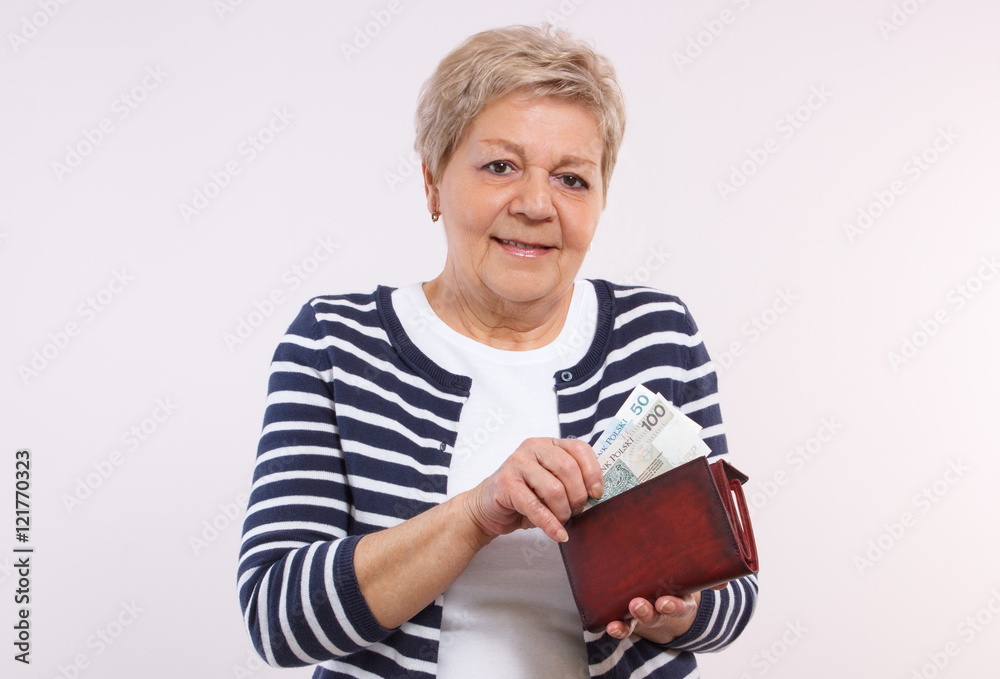Happy senior female holding wallet with polish currency money, concept ...
