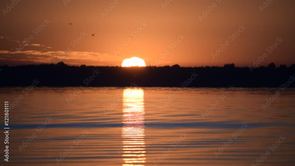 Sunrise over water of river or lake with sun path reflection on water ...