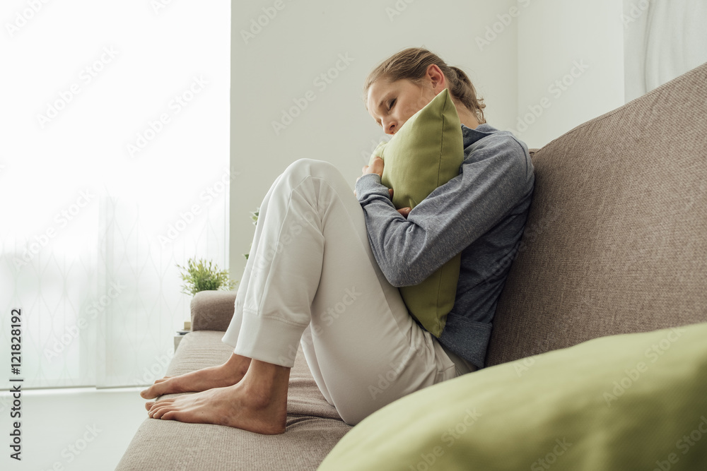 Sad woman hugging a pillow Stock Photo | Adobe Stock