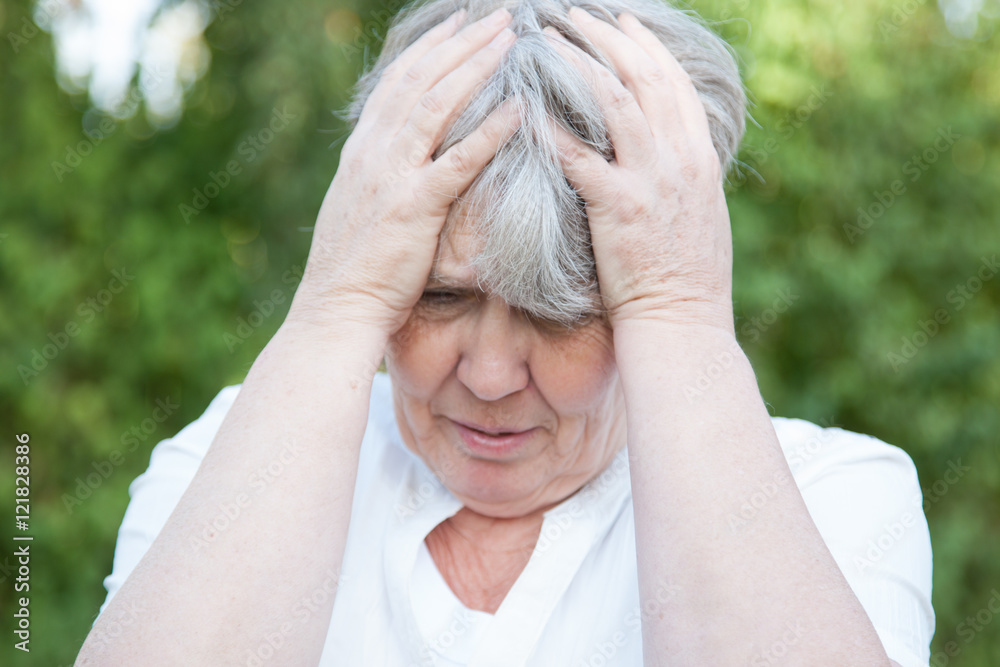 Old age woman holding her head Stock Photo | Adobe Stock