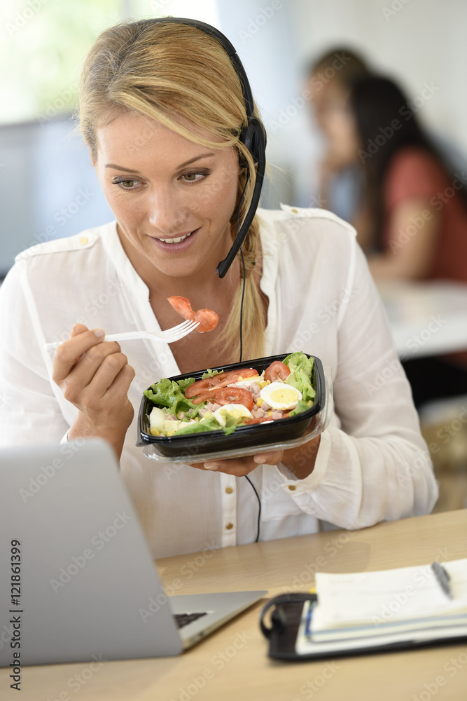 Busy customer service manager eating lunch in office Stock Photo ...