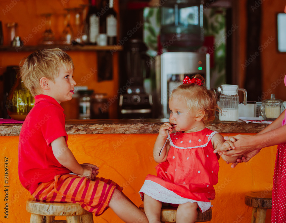 little boy and toddler girl sitting at the bar, kids eating out Stock ...