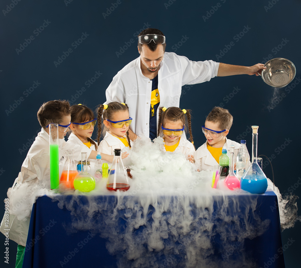 Happy kids with scientist doing science experiments in the laboratory ...