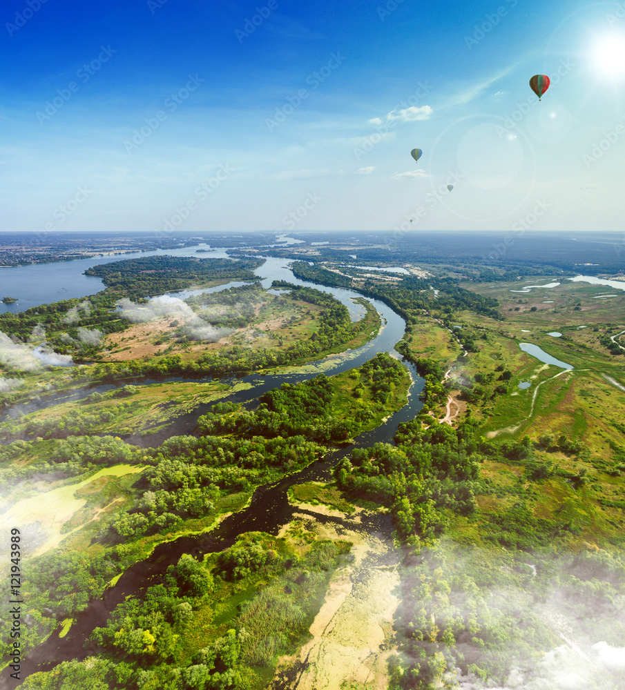 Summer landscape in rich colors from above with balloons in the ...