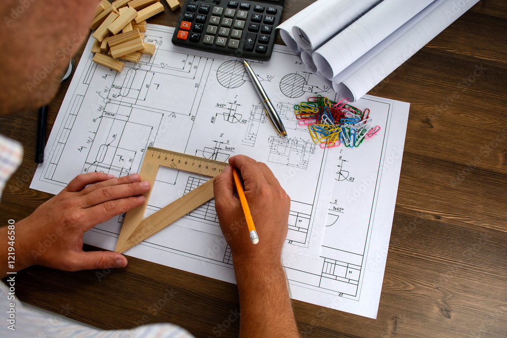 Mechanical engineer at work. Technical drawings. Paper with technical ...