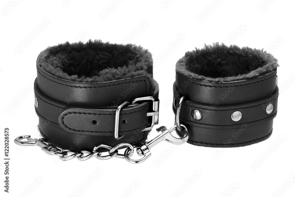 Pair of a black color leather handcuffs isolate on white background ...