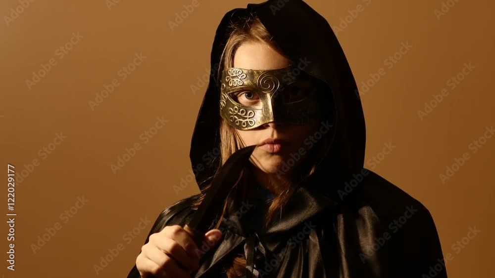 Portrait of a horror Halloween model - satanic teen girl priest or ...