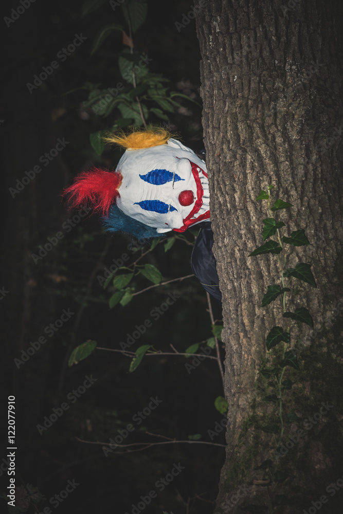 scary clown behind tree Stock Photo | Adobe Stock