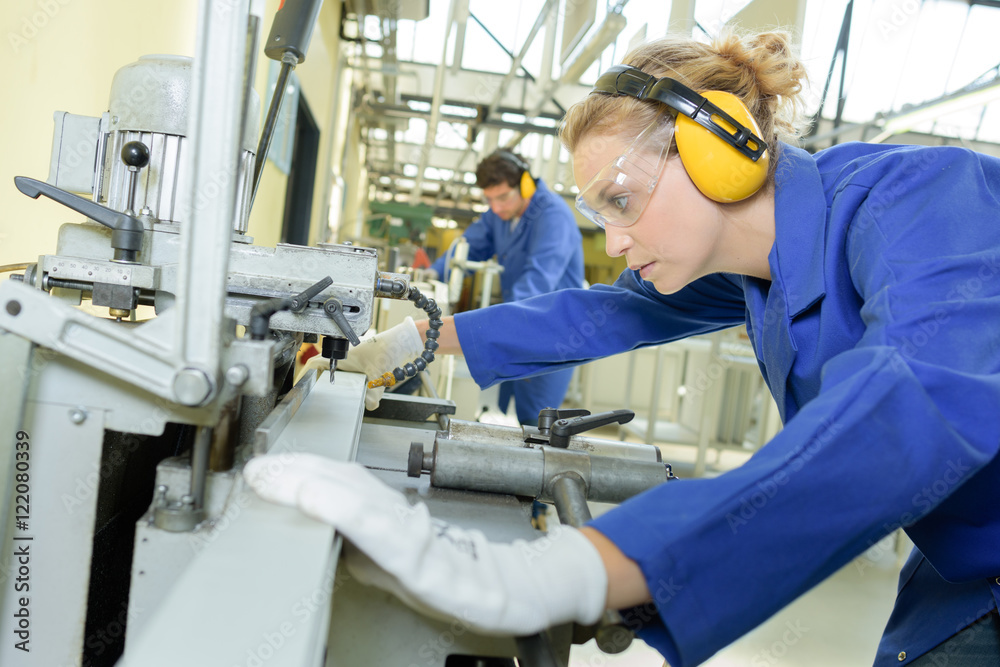 Woman using industrial machine Stock Photo | Adobe Stock