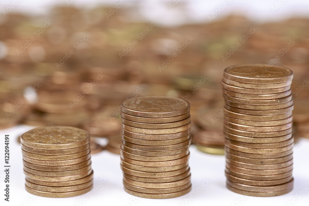 Euro coins of five cents stacked in piles of different heights in front ...
