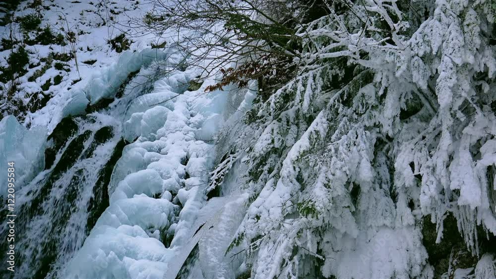 Wonderful waterfall in winter time with traces of ice melting in pure ...