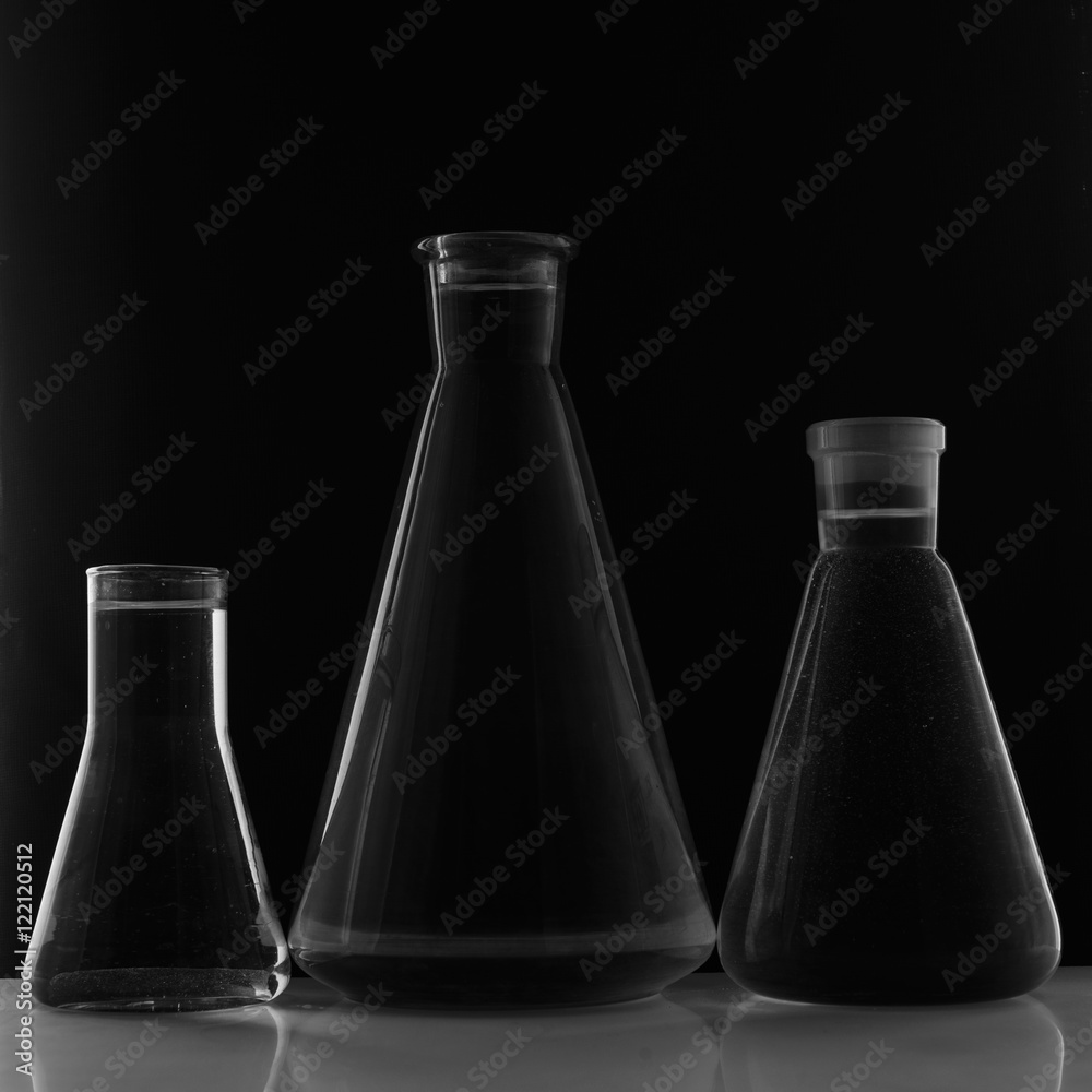 Laboratory equipment, three glass flask on black background Stock Photo ...