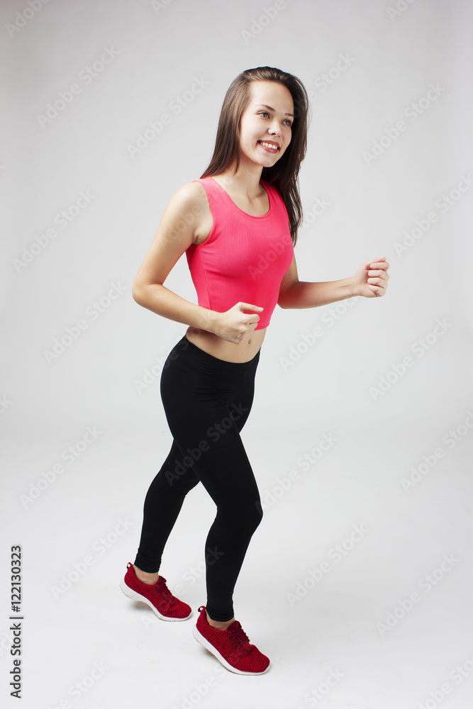Attractive brunette girl running on a white background Stock Photo ...