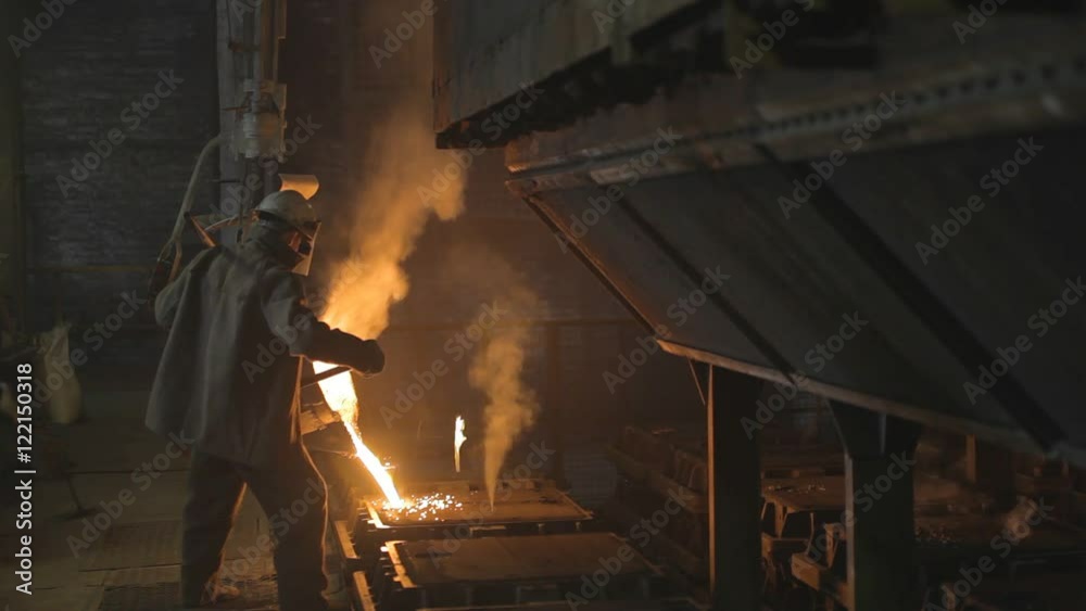 Worker pouring red-hot steel in a steel mill Stock Video | Adobe Stock