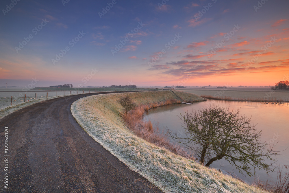 Typical Dutch landscape with a dike, in winter at sunrise Stock Photo ...