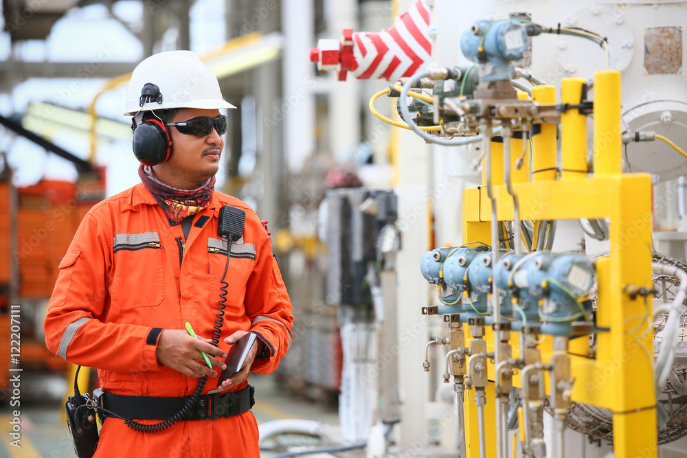operator recording operation of oil and gas process at oil and rig ...