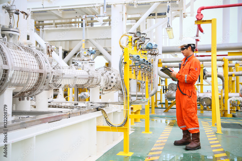 operator recording operation of oil and gas process at oil and rig ...