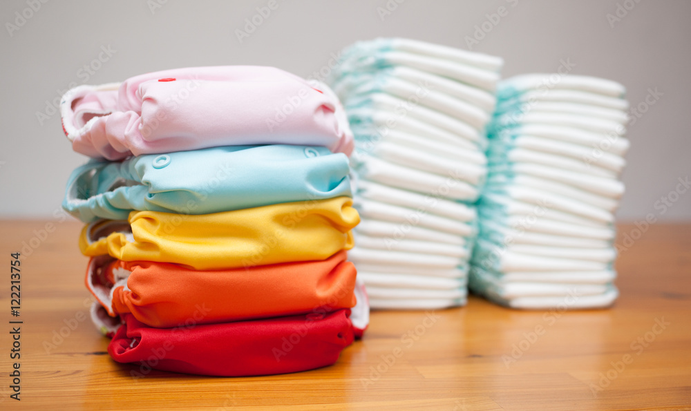 Stacks of disposable diapers and modern cloth diapers Stock Photo ...