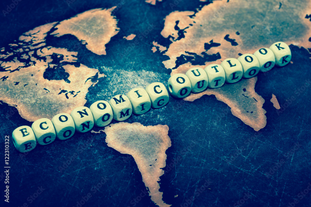 ECONOMIC OUTLOOK on grunge world map Stock Photo | Adobe Stock