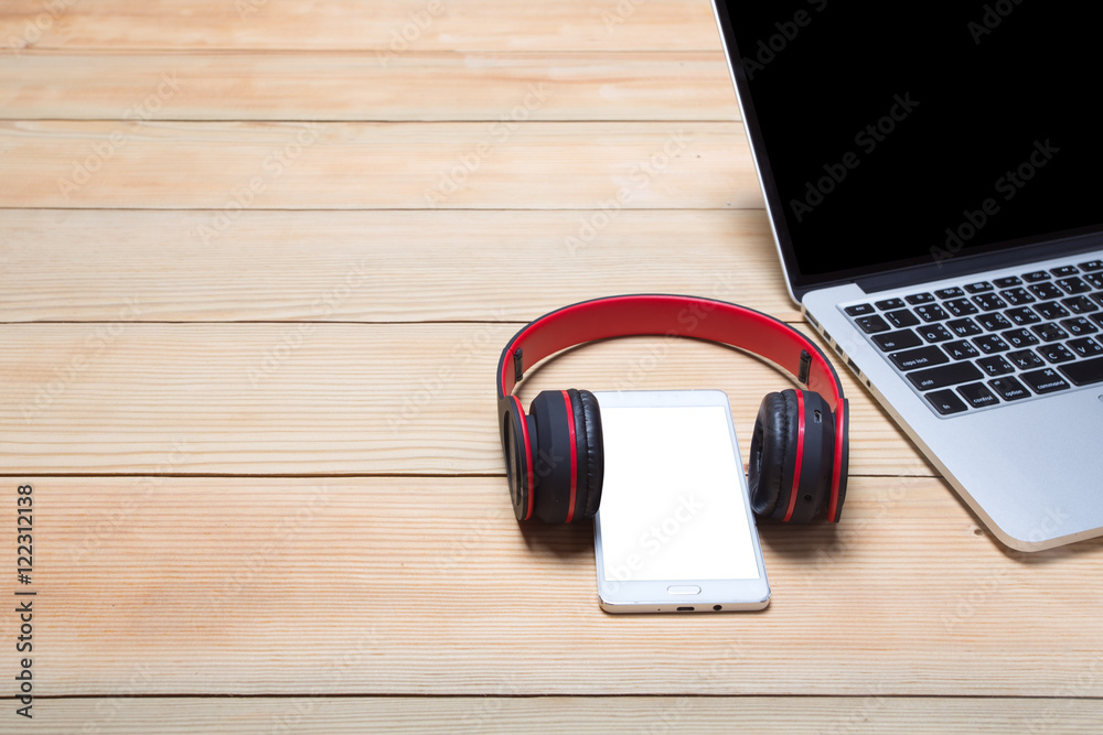 smartphone ,laptop with wireless headphones on wooden background. Top ...