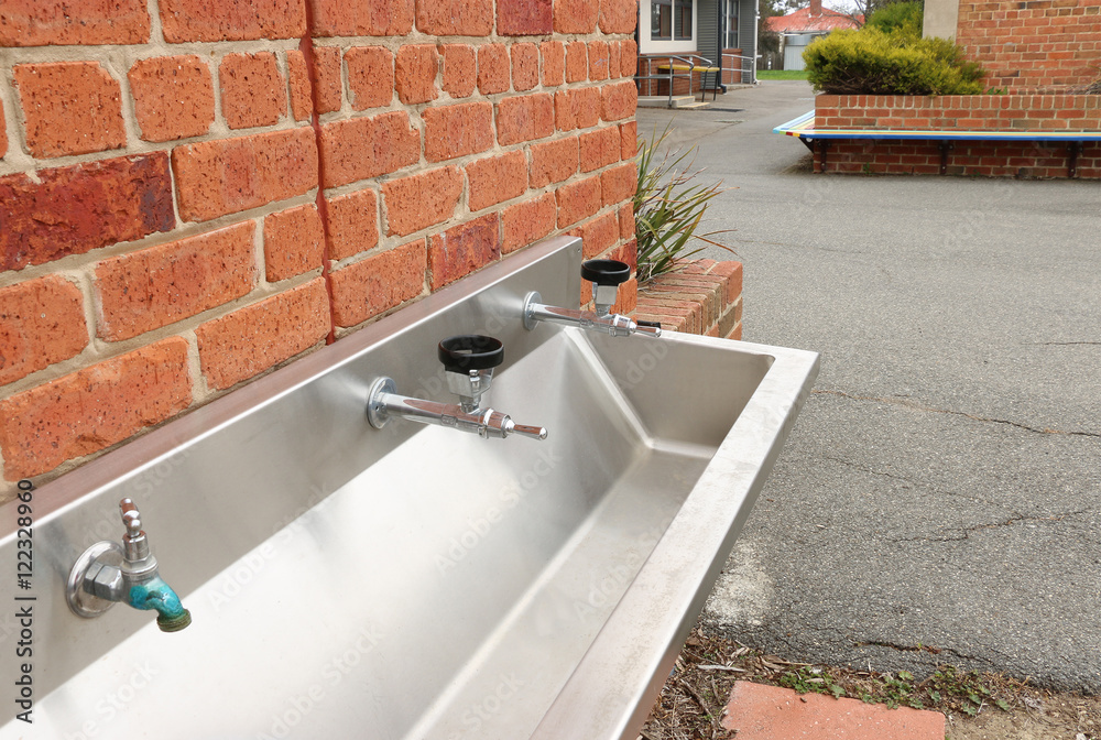 Drinking fountain, tap and trough in a school yard Stock Photo | Adobe ...