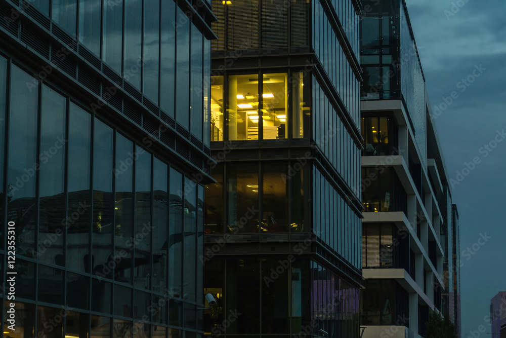 Perfect modern office buildings at dusk. Working time. Lonely window ...