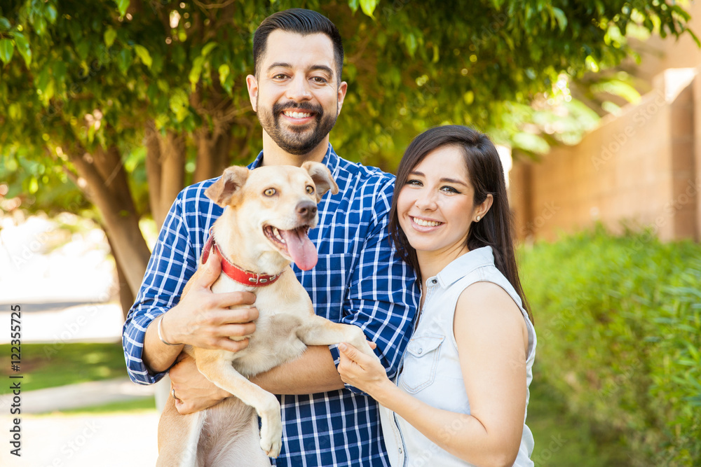 Beautiful couple with a dog Stock Photo | Adobe Stock