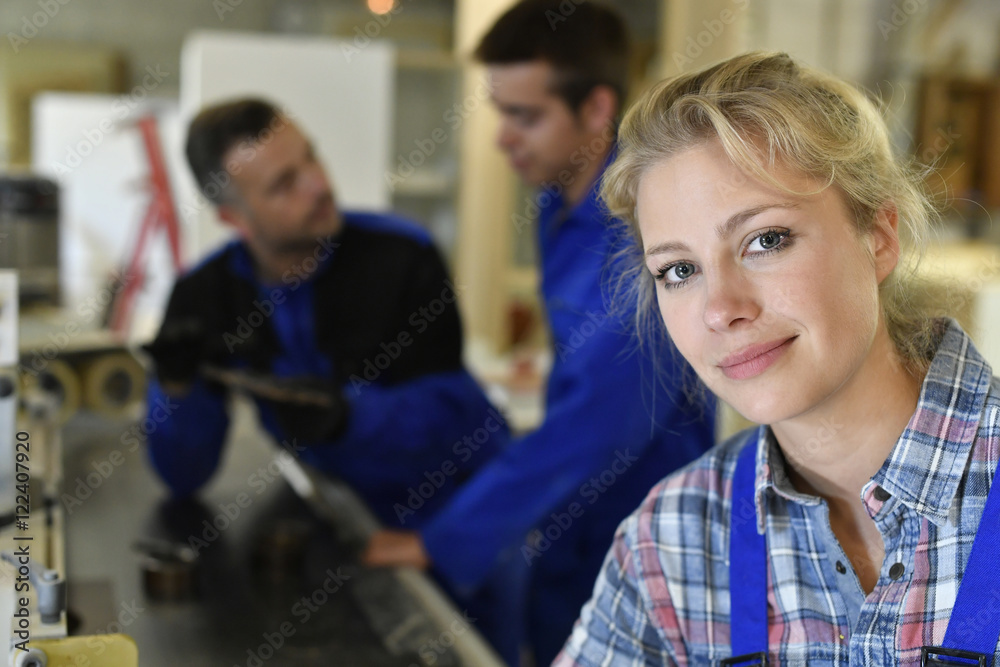 Portrait of young woman apprentice in workshop Stock-Foto | Adobe Stock