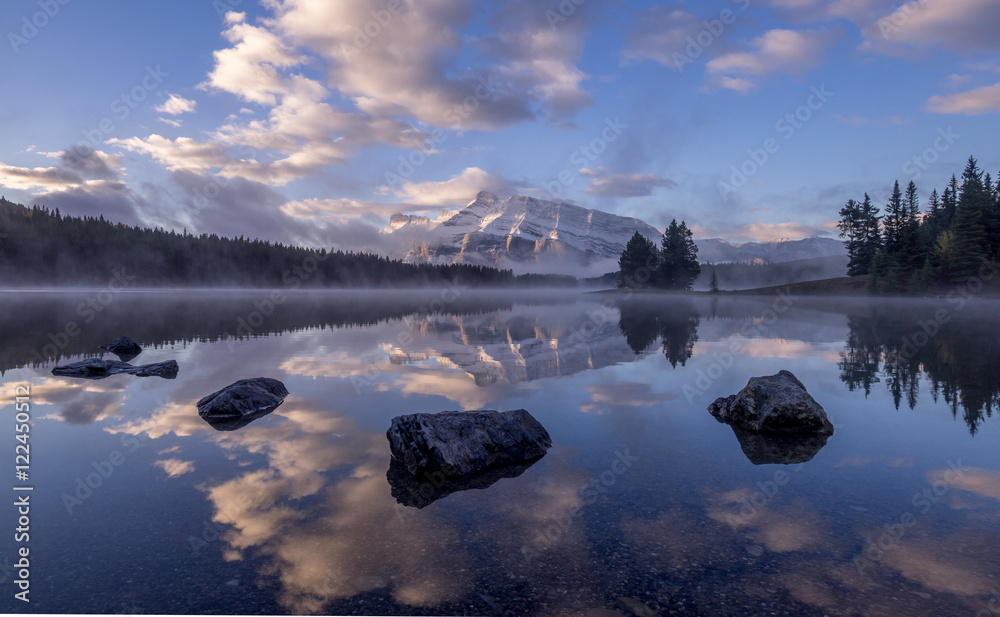 Rundle Mountain reflecting in Two Jack Lake in Banff National Park at ...