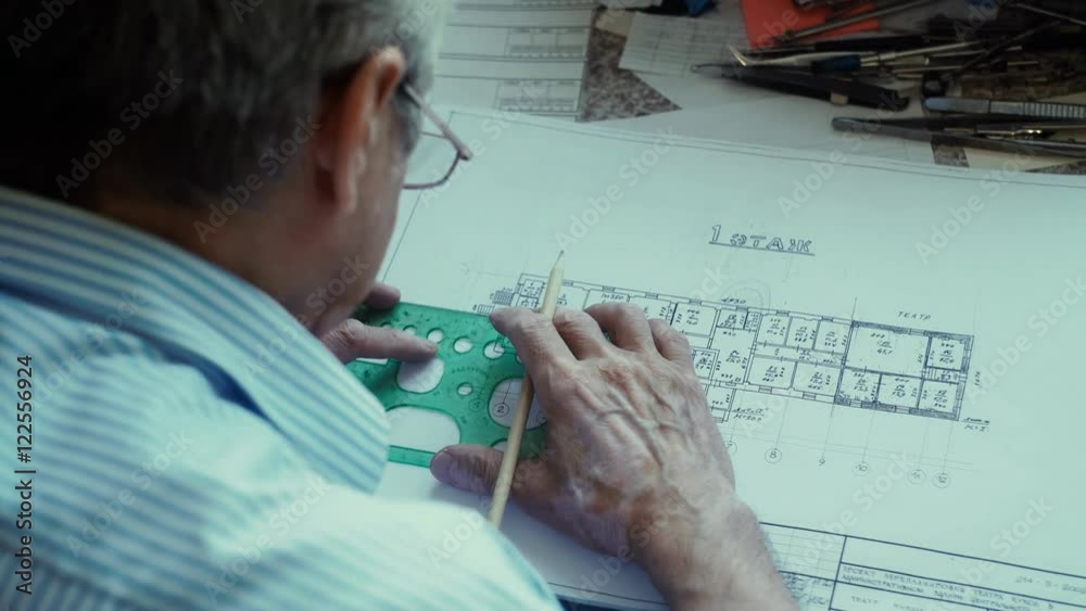 Architect at work. Drawing. Draftsman. Male architect. Architect puts a ...