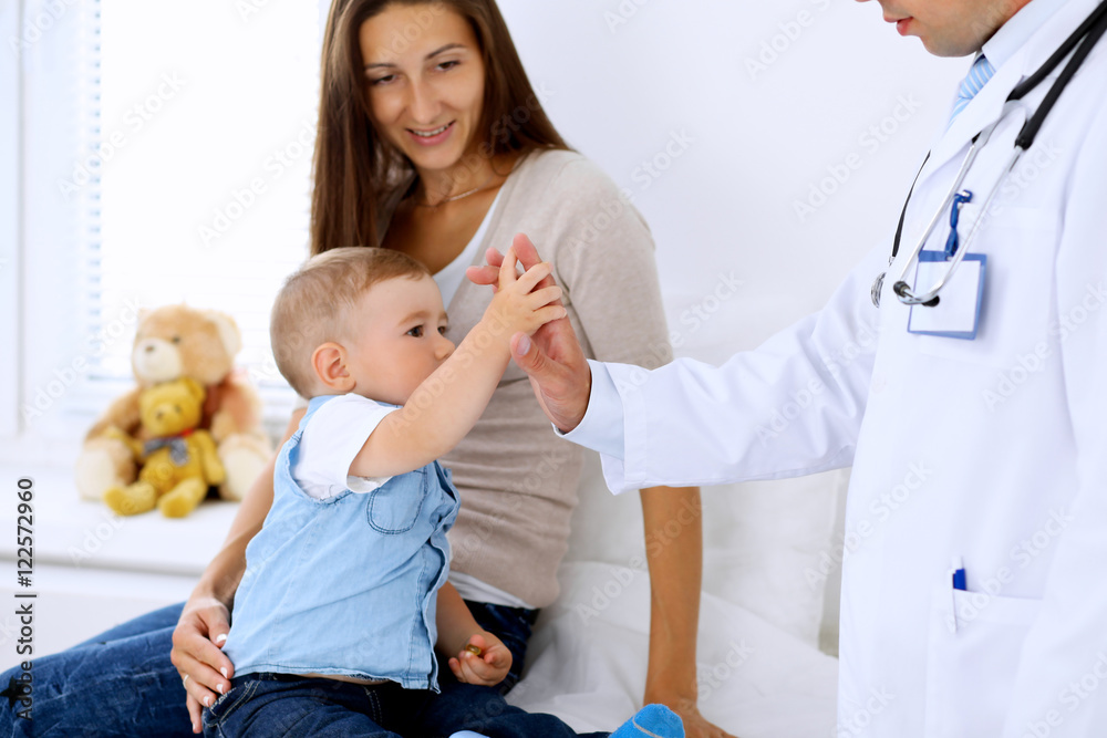 Little boy child with his mother at health exam at doctor's office ...