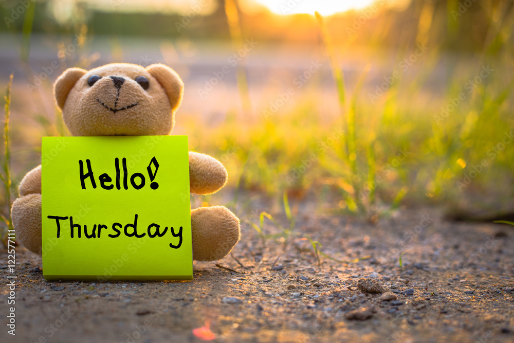 Hello Thursday on sticky note with teddy bear on nature background ...