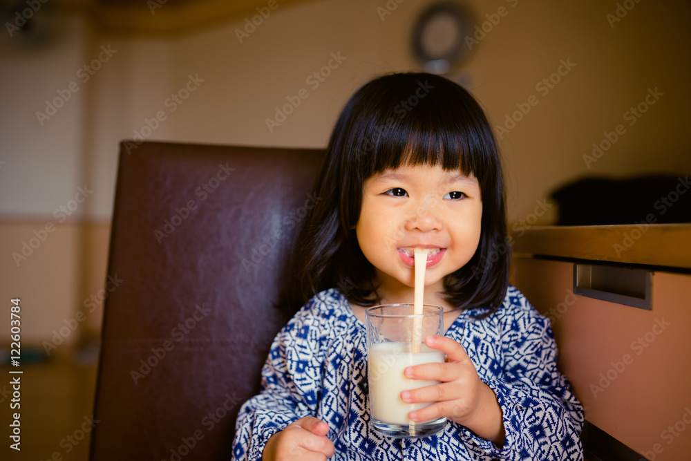 Little girl drinking soy milk from a cup with a straw,Cute little girl ...